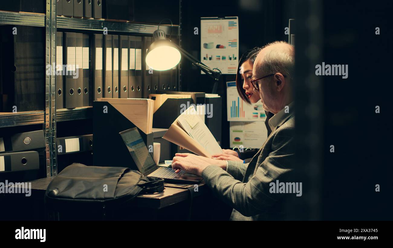 Team of private officers reading confidential folders with important ...
