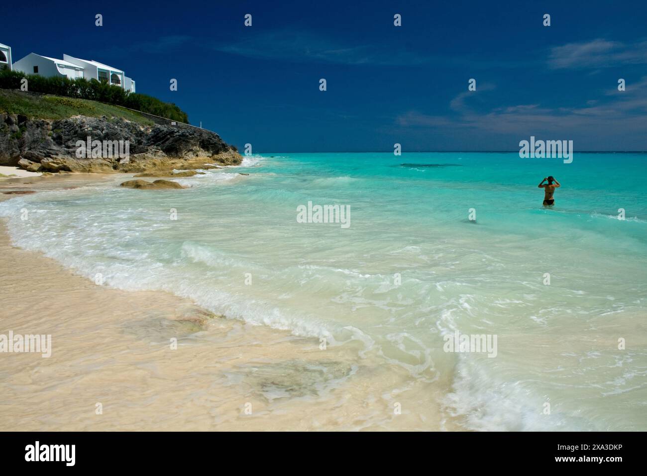 A tropical beach, in Bermuda, with a clear blue sea, on a summers day ...