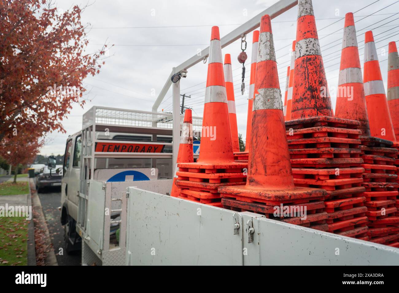 Work truck loaded with Temporary signs and dirty orange traffic cones ...