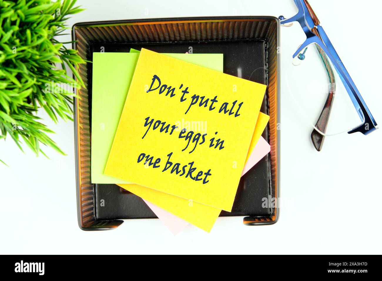 Don't put all your eggs in one basket text on a yellow sticker in a ...