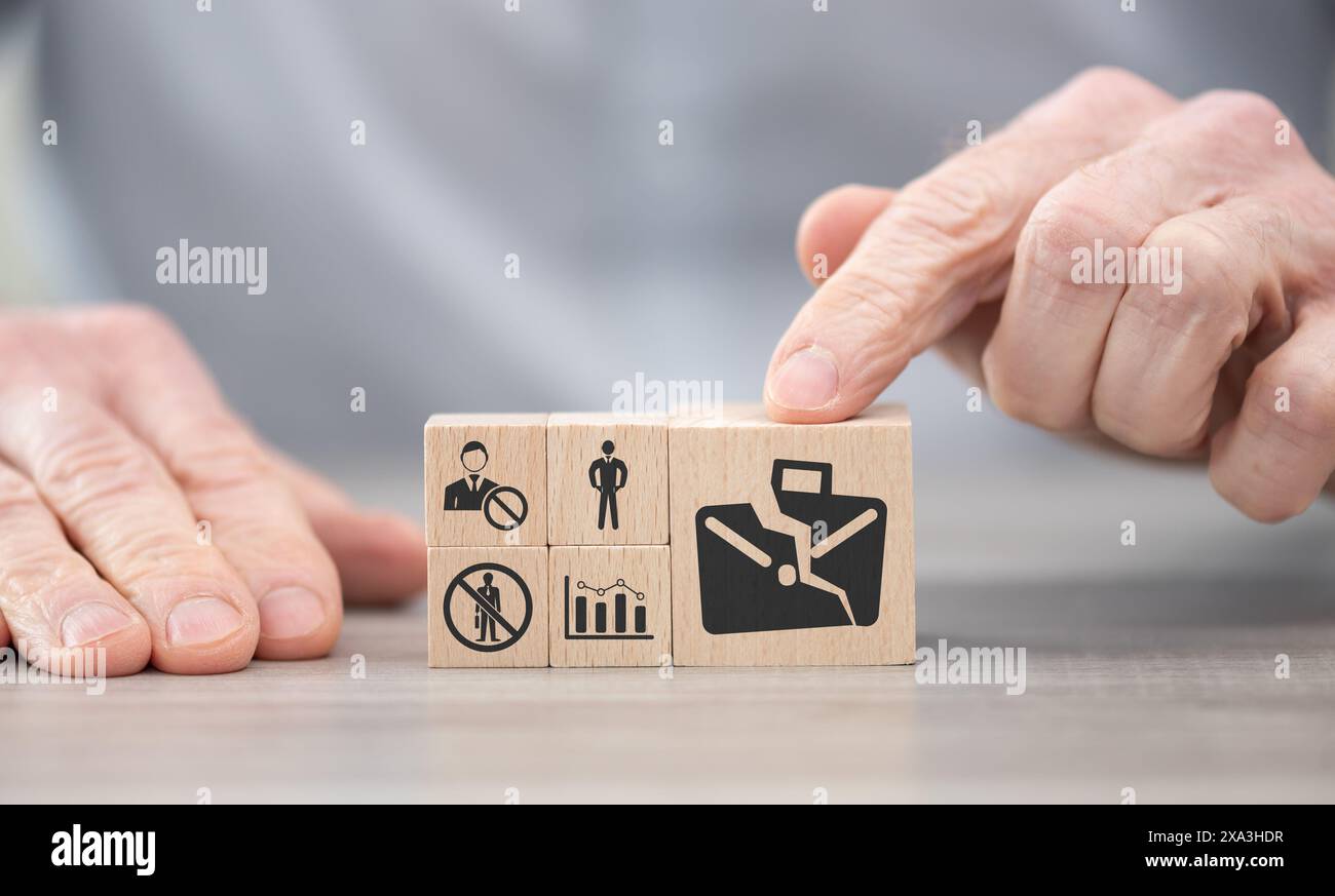 Wooden blocks with symbol of job loss concept Stock Photo - Alamy