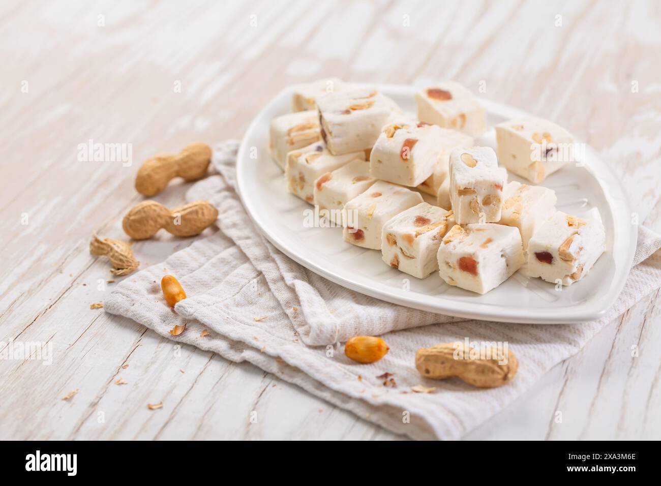 Soft nougat with peanuts on a plate, chewy sweets with nuts Stock Photo ...