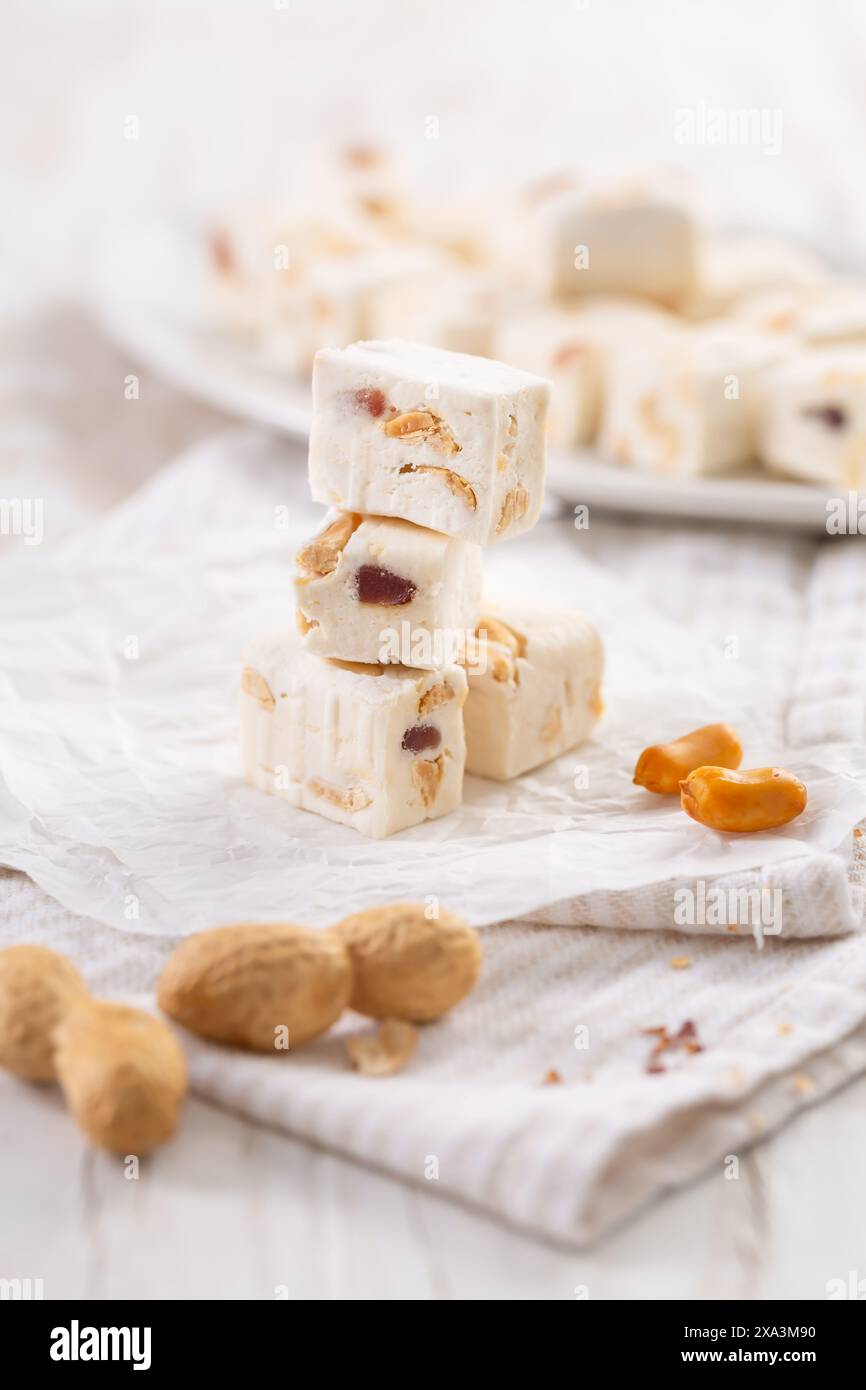 Soft nougat with peanuts on a plate, chewy sweets with nuts Stock Photo ...