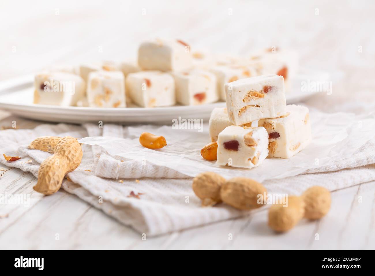 Soft nougat with peanuts on a plate, chewy sweets with nuts Stock Photo ...