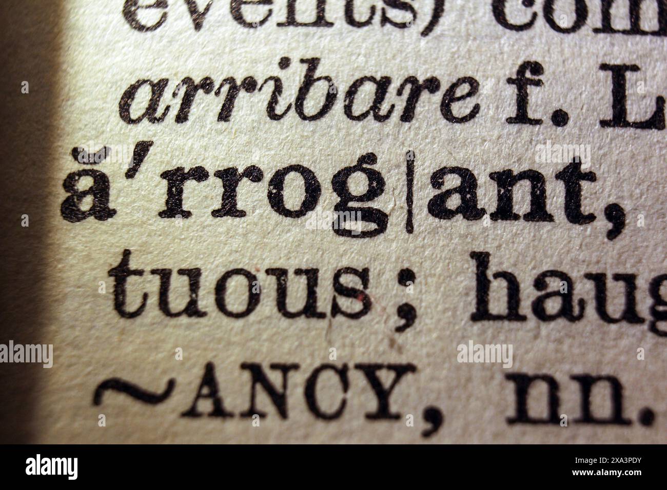 Word arrogant on dictionary page, macro close-up Stock Photo - Alamy