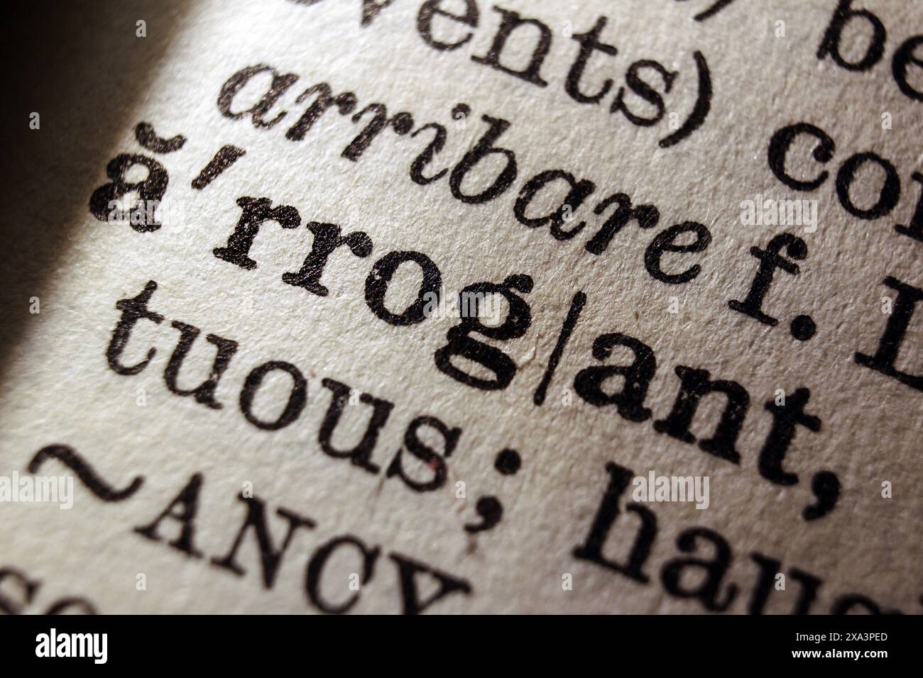 Word arrogant on dictionary page, macro close-up Stock Photo - Alamy
