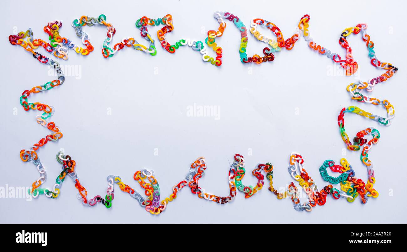 Frame or border made from plastic chain links letters on off white ...