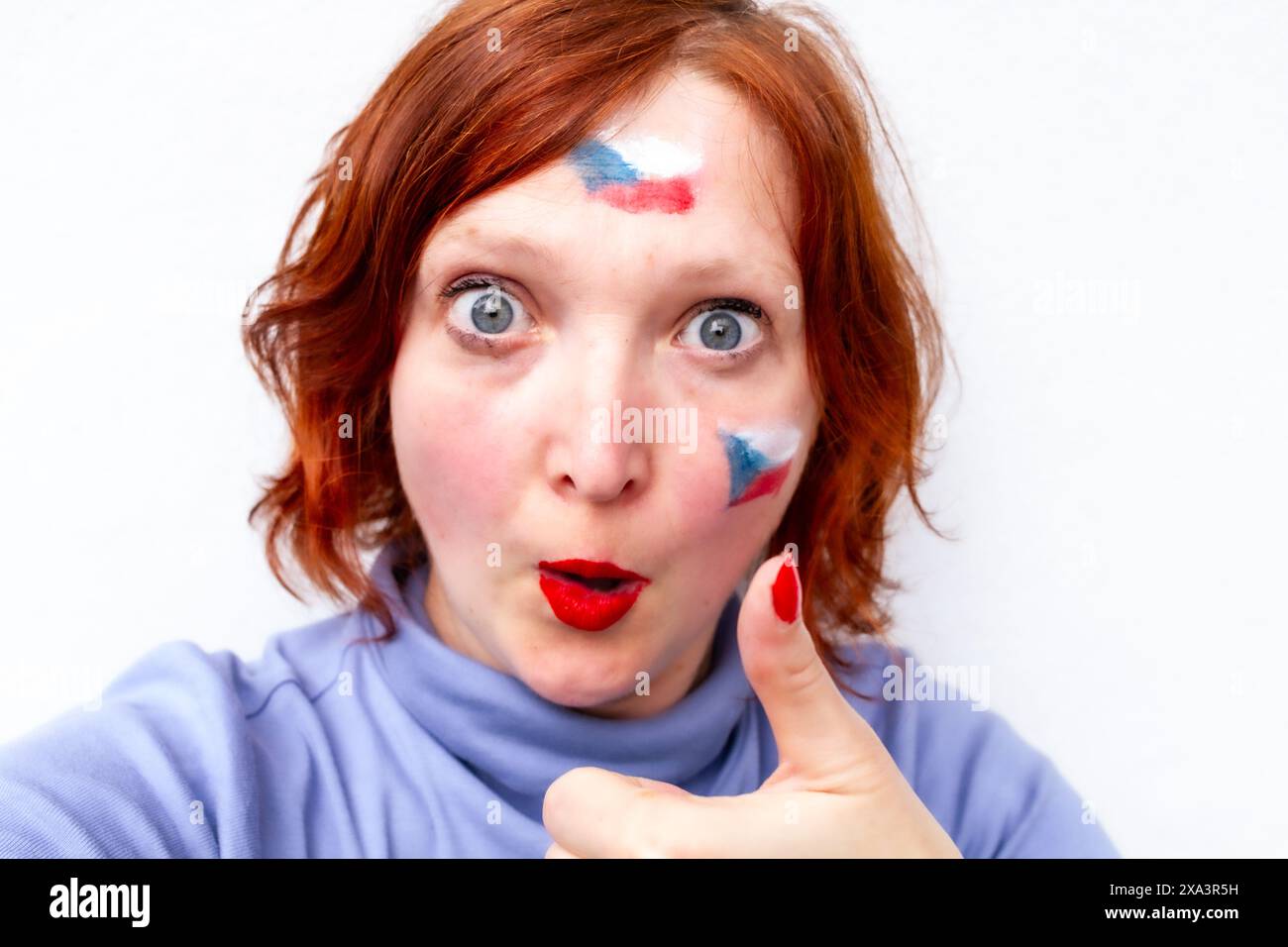Selfie of Czech female sport fan with painted Czech flag on the face ...