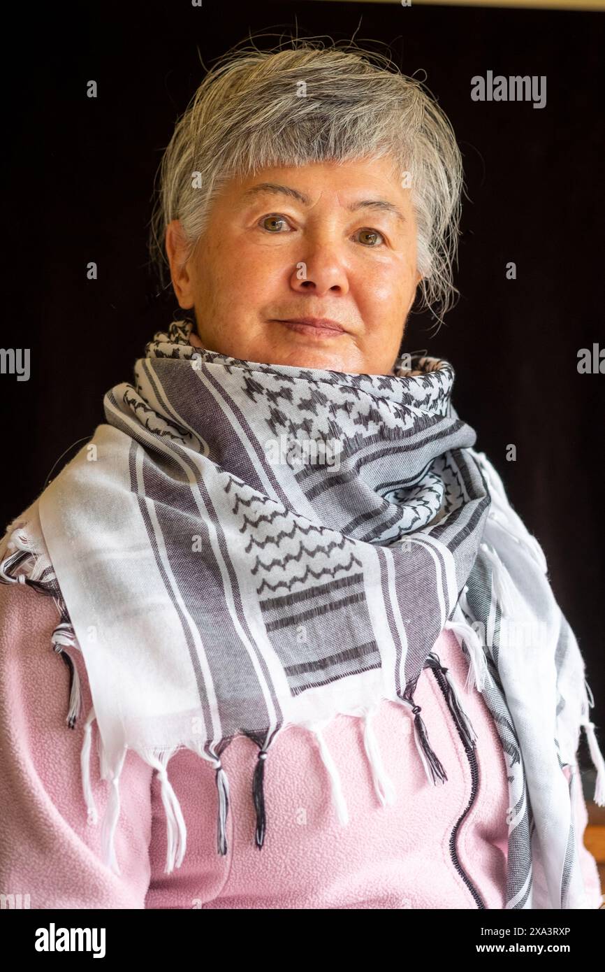 An elderly Eurasian Chinese/Italian woman wearing a keffiyeh to ...