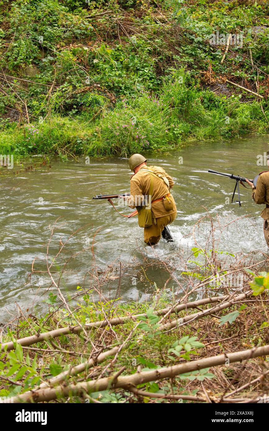 WW II historical reenactment. A Soviet infantry soldier crossing the ...