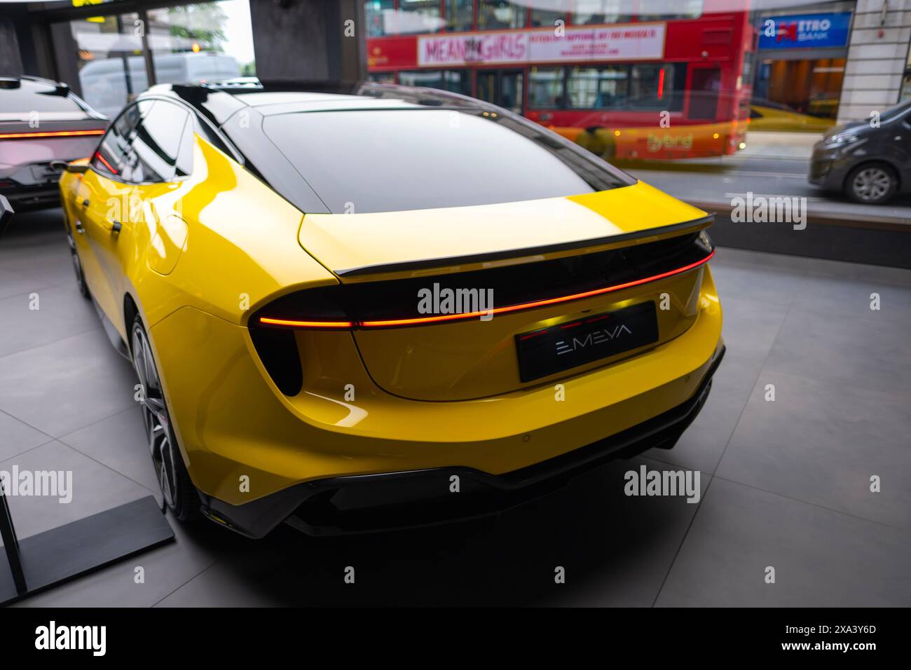 rear view yellow battery-Electric Hyper-GT Lotus Emeya in showroom ...