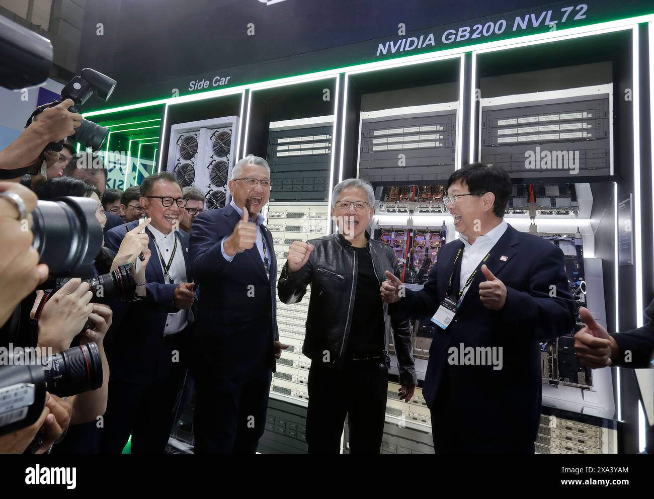President and CEO of Nvidia Corporation Jensen Huang, center, cheers ...
