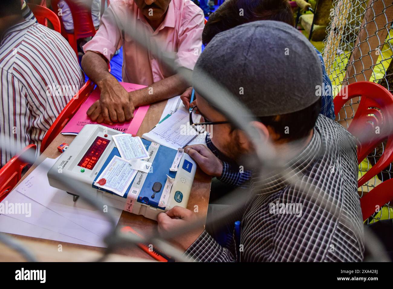 An electoral official counts votes from an Electronic Voting Machine ...