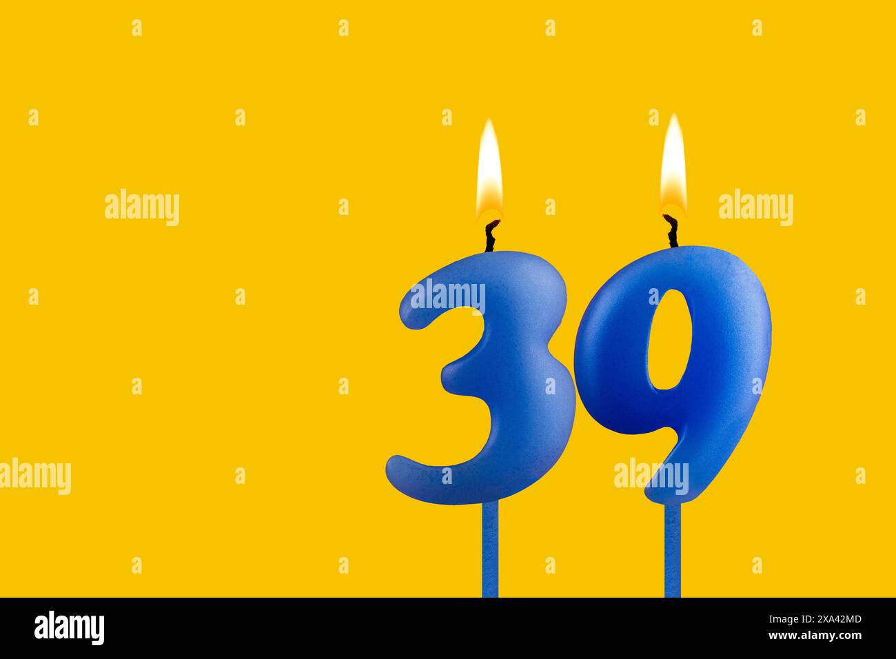 Blue birthday candle on yellow background - Number 39 Stock Photo - Alamy