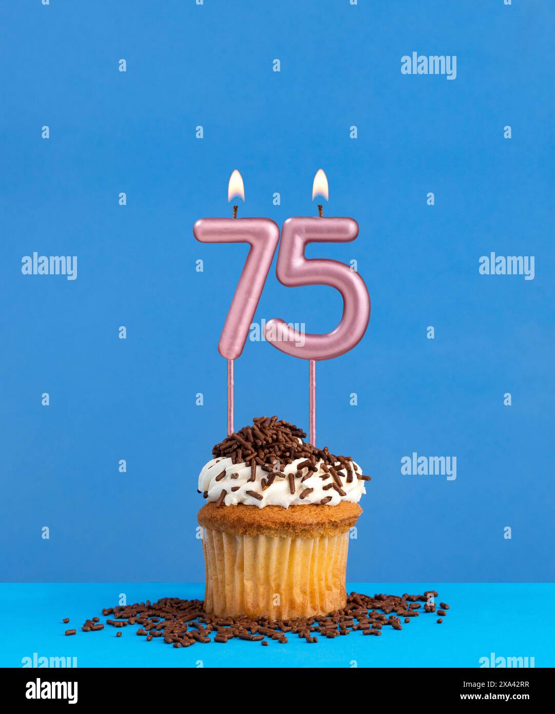 Birthday candle with cupcake on blue background - Number 75 Stock Photo ...
