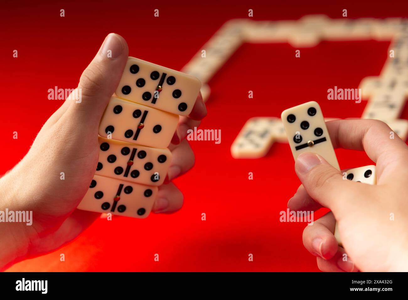 Domino players hands holding rectangular number blocks. Board game. Red ...