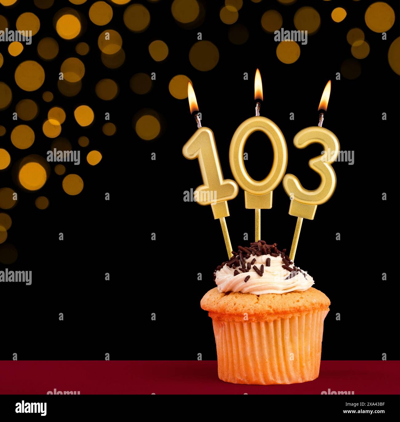 Number 103 birthday candle - Cupcake on black background with out of ...