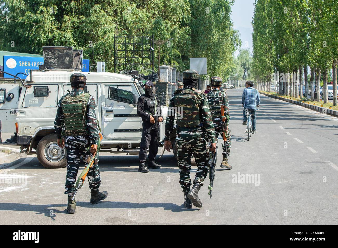 Indian paramilitary troopers stand on guard outside the venue where ...