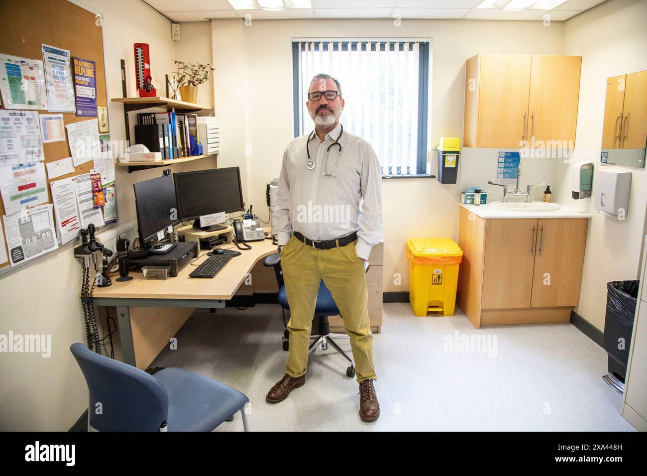 Doctor standing in a medical office Stock Photo - Alamy