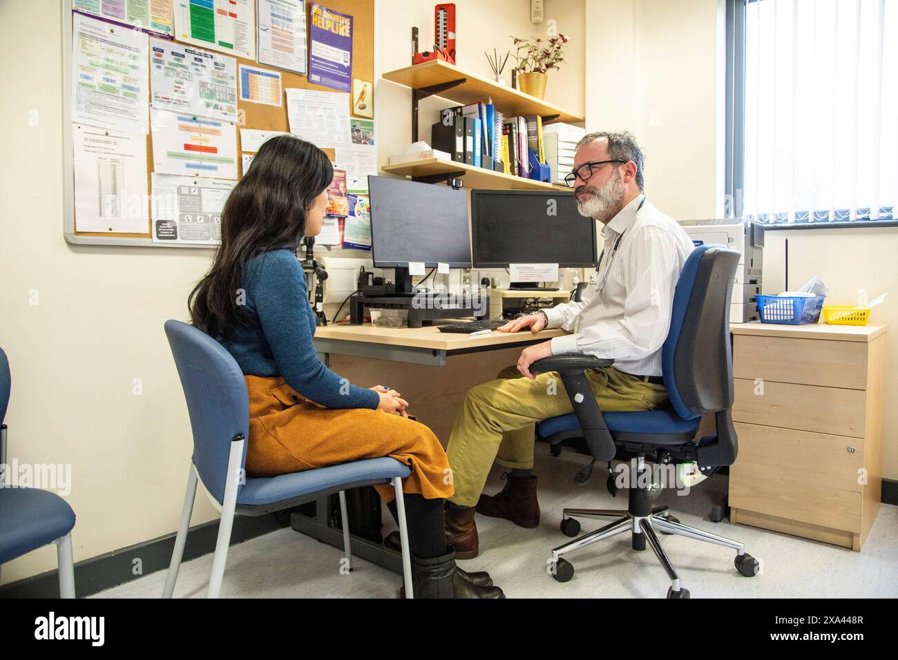 Doctor consulting with a patient in an office of a medical practice ...