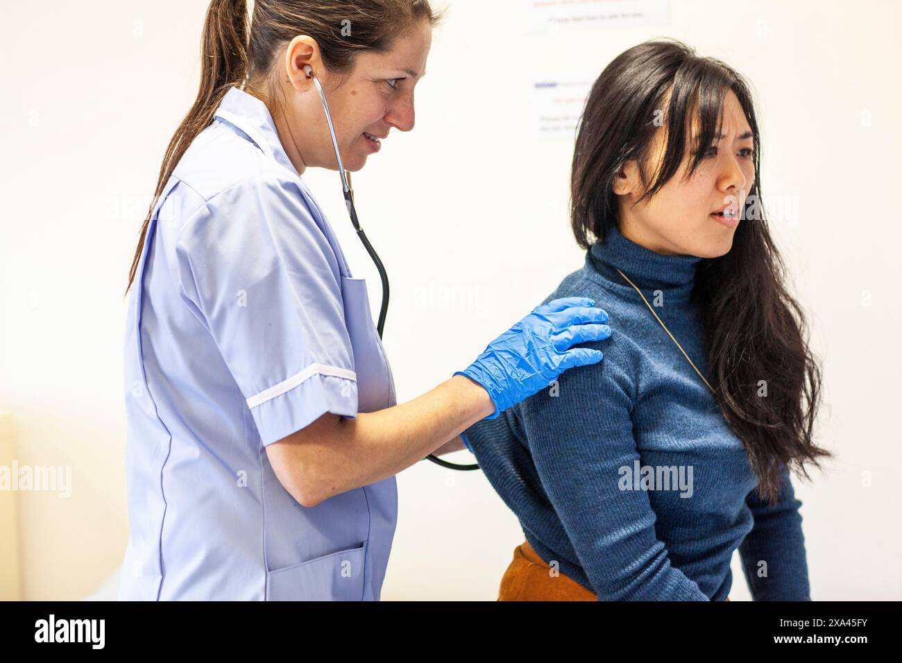 Nurse checking patient's heartbeat with stethoscope Stock Photo - Alamy