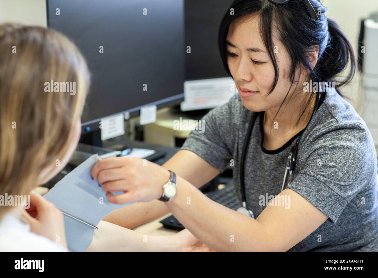 Doctor preparing blood pressure test with a patient in a medical ...