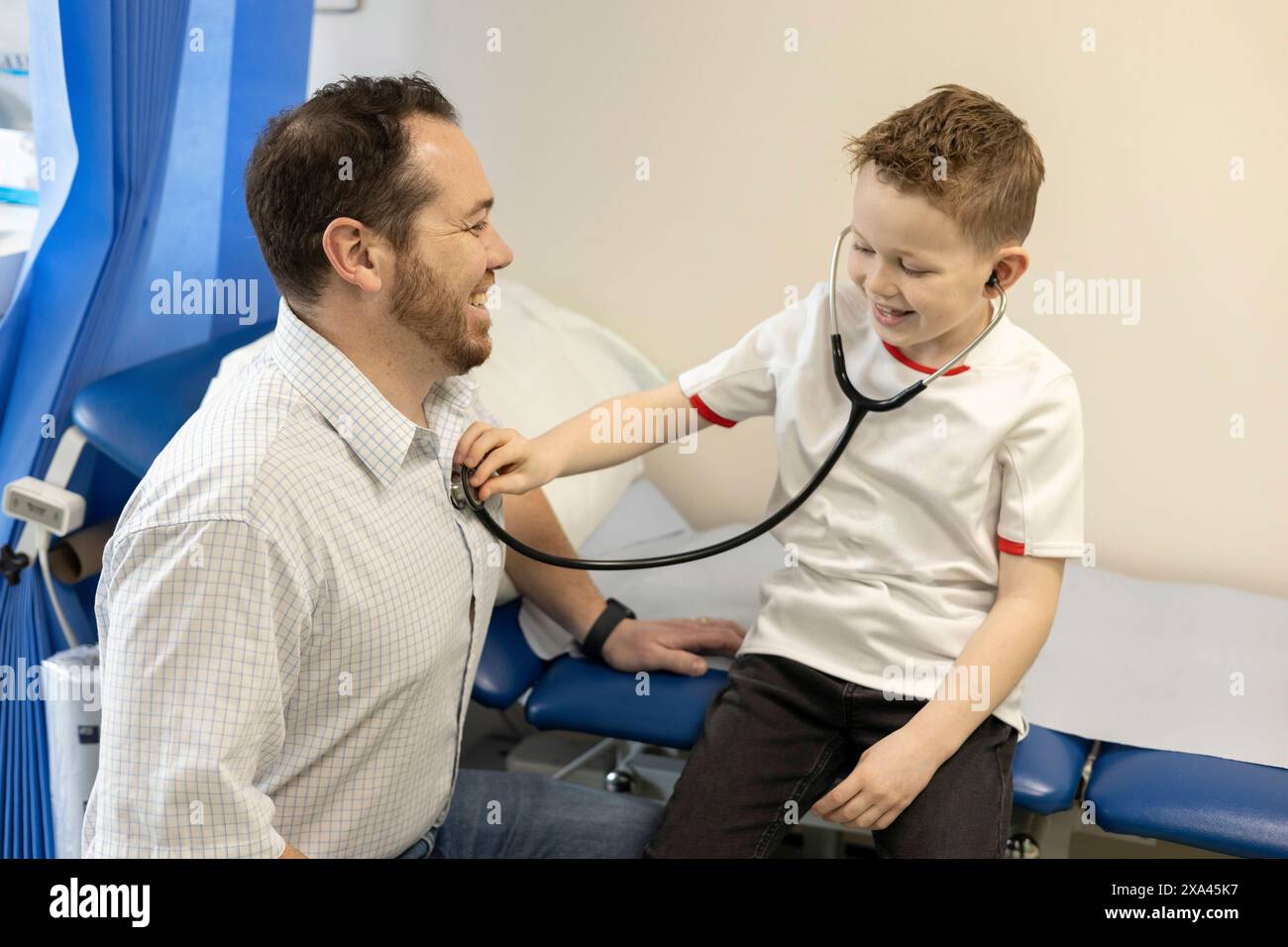 Child playing doctor with an adult doctor Stock Photo - Alamy