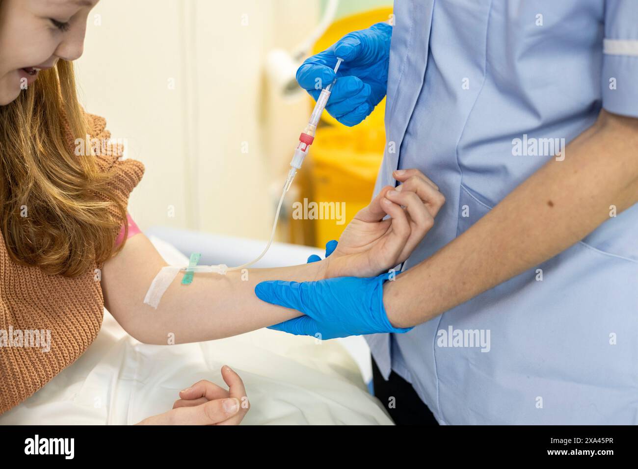 Nurse giving injection to a young patient Stock Photo - Alamy