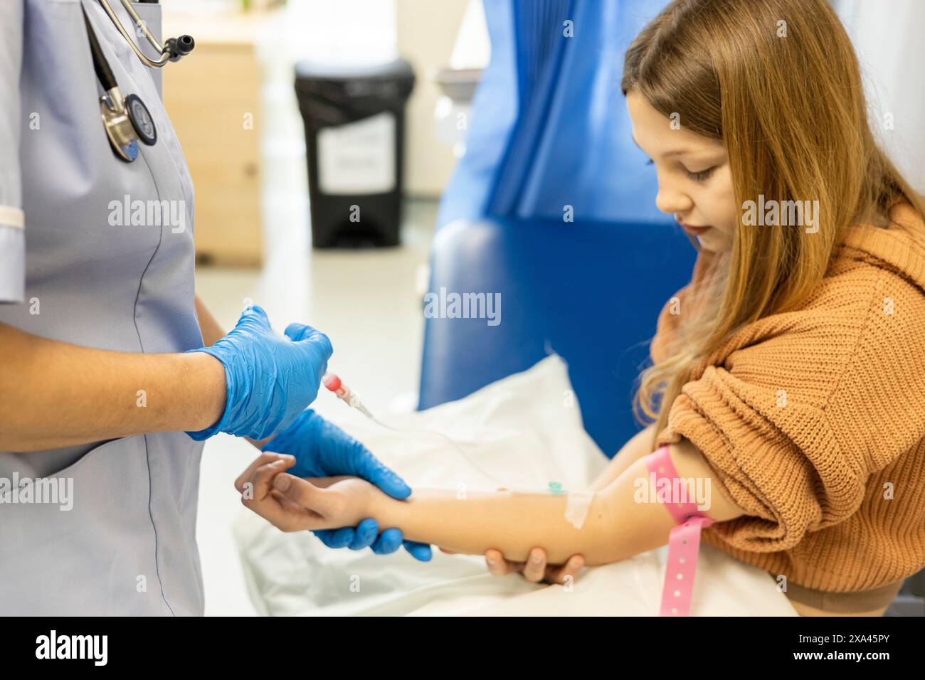 Nurse giving injection to a young patient Stock Photo - Alamy