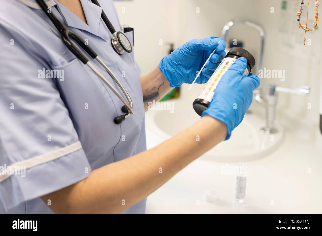Hands in gloves handling a test result Stock Photo - Alamy