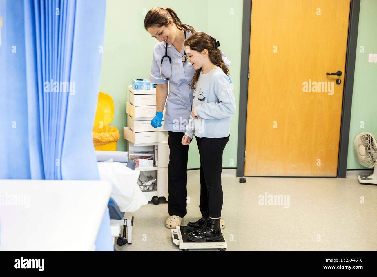 Nurse weighing patient on scale hi-res stock photography and images - Alamy