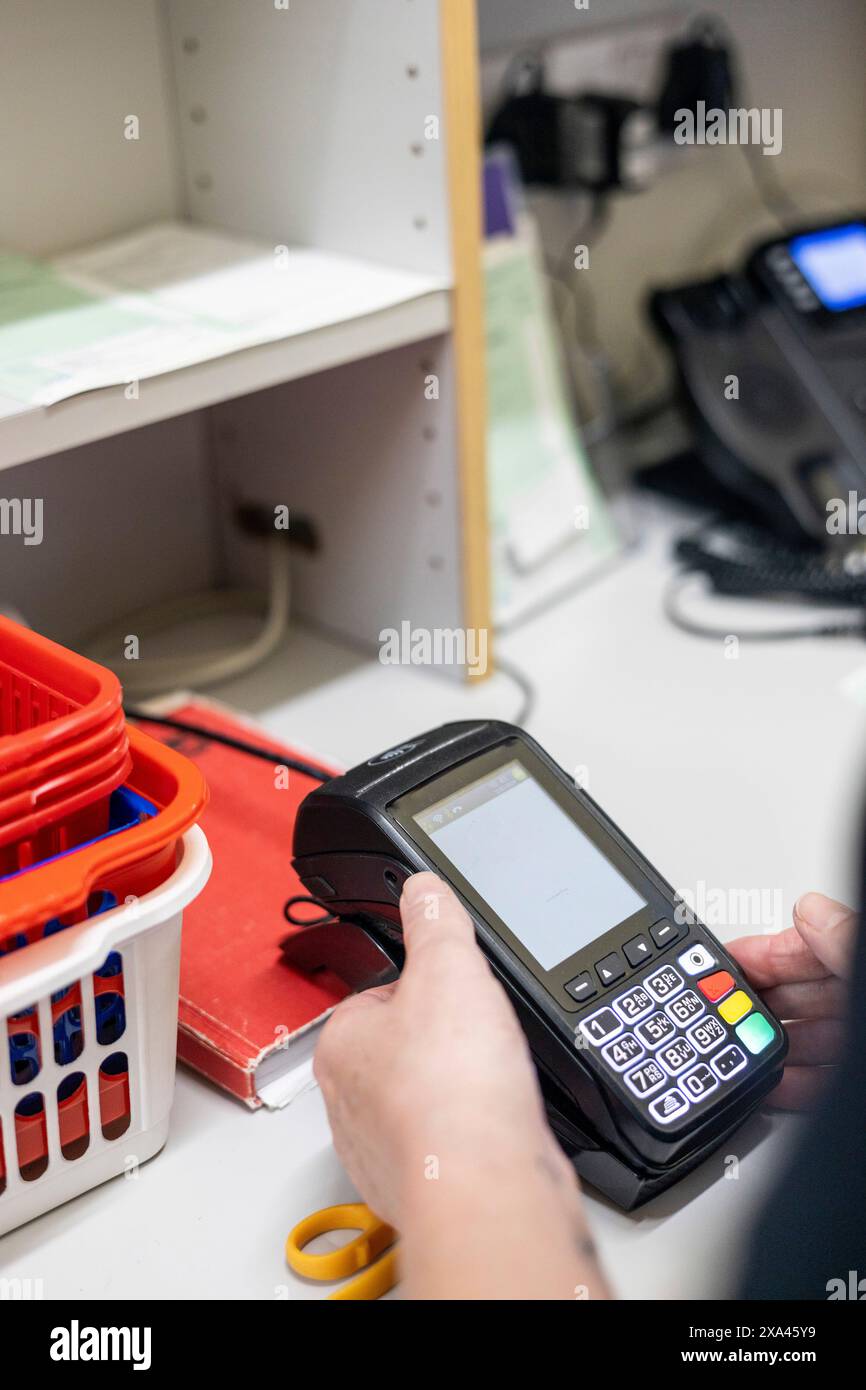 Hand using a handheld scanner in a workspace of a medical practice ...
