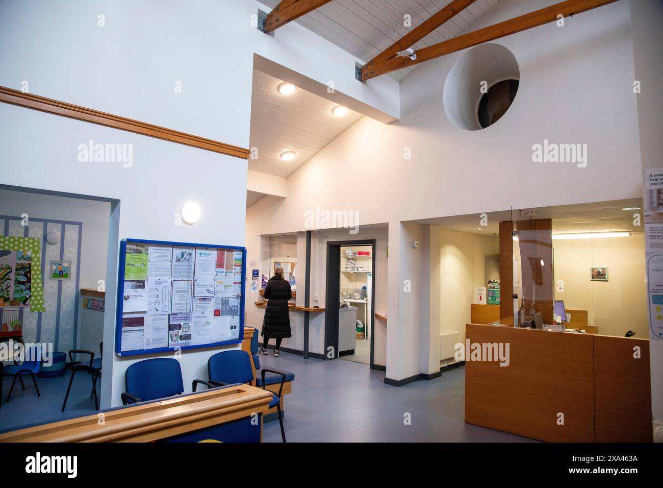 Interior of a brightly lit medical practice with waiting area and ...