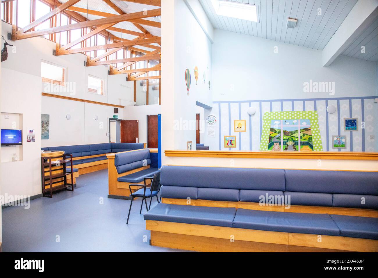 Modern waiting area with comfortable seating and informational displays ...