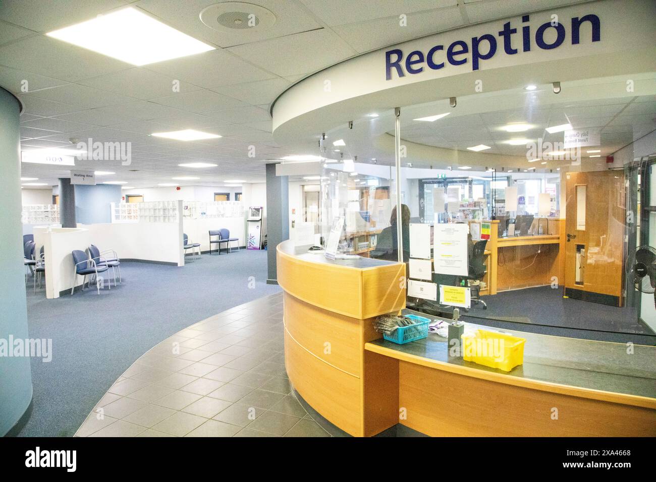 Modern hospital reception area with curved desk and signage Stock Photo ...