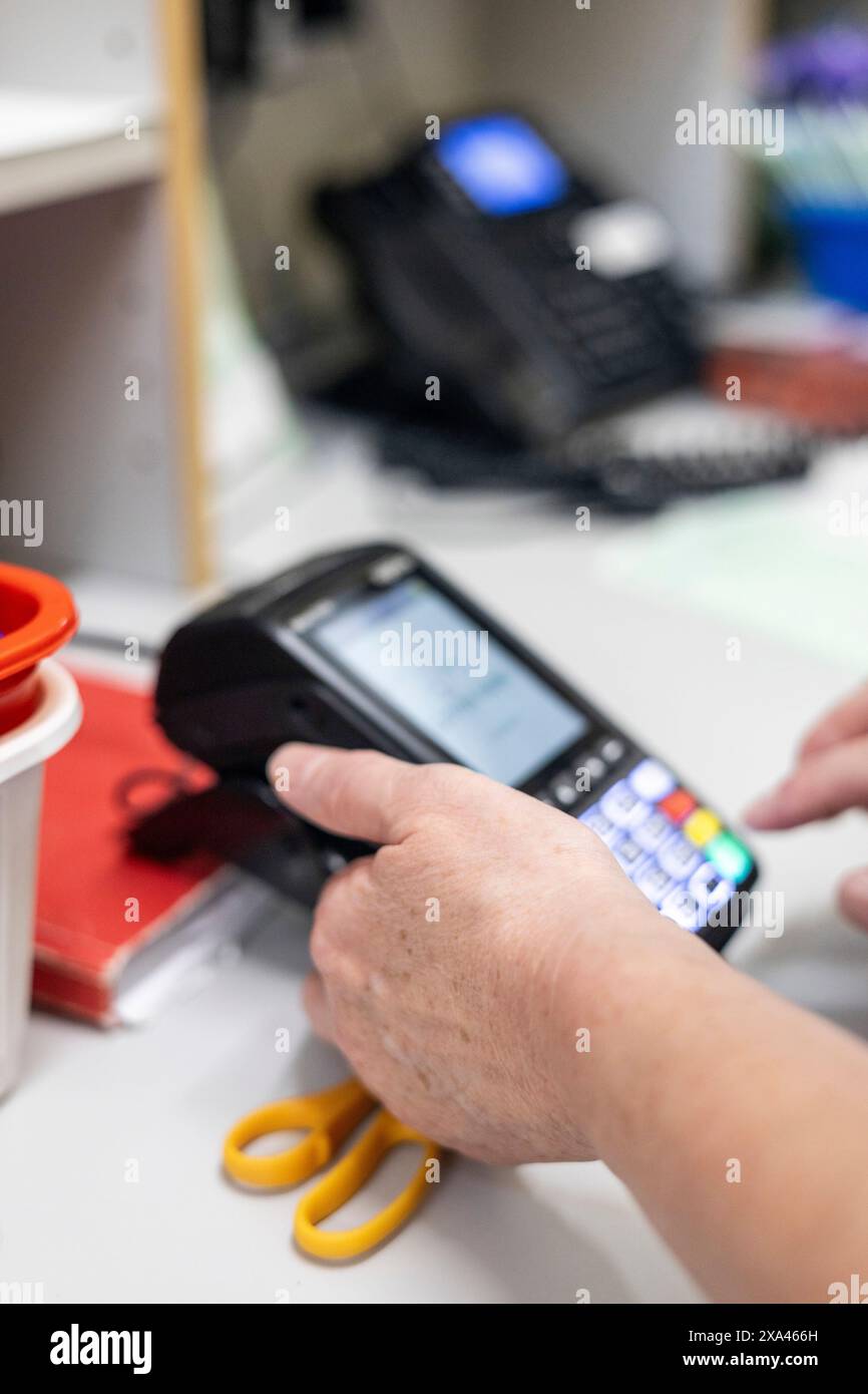 Hand operating a card payment machine in a medical practice Stock Photo ...