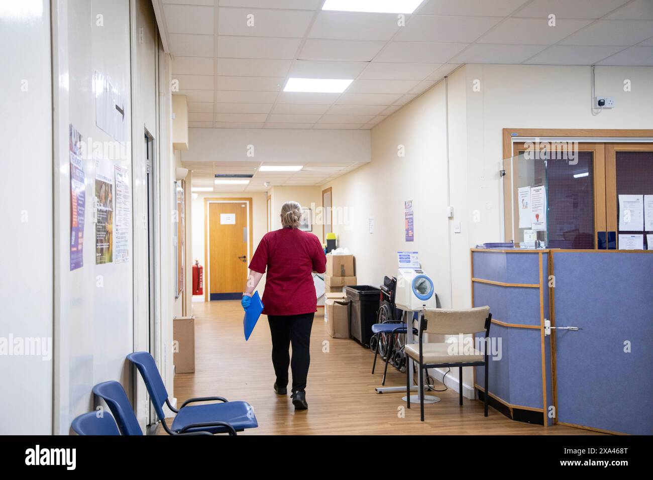 Healthcare worker walking in a hospital corridor Stock Photo - Alamy