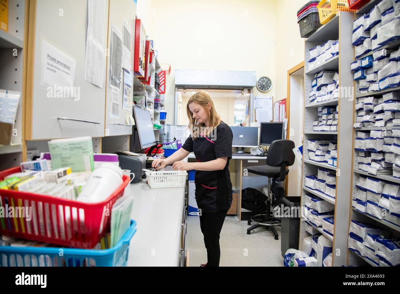 Pharmacist organizing medication in a pharmacy Stock Photo - Alamy