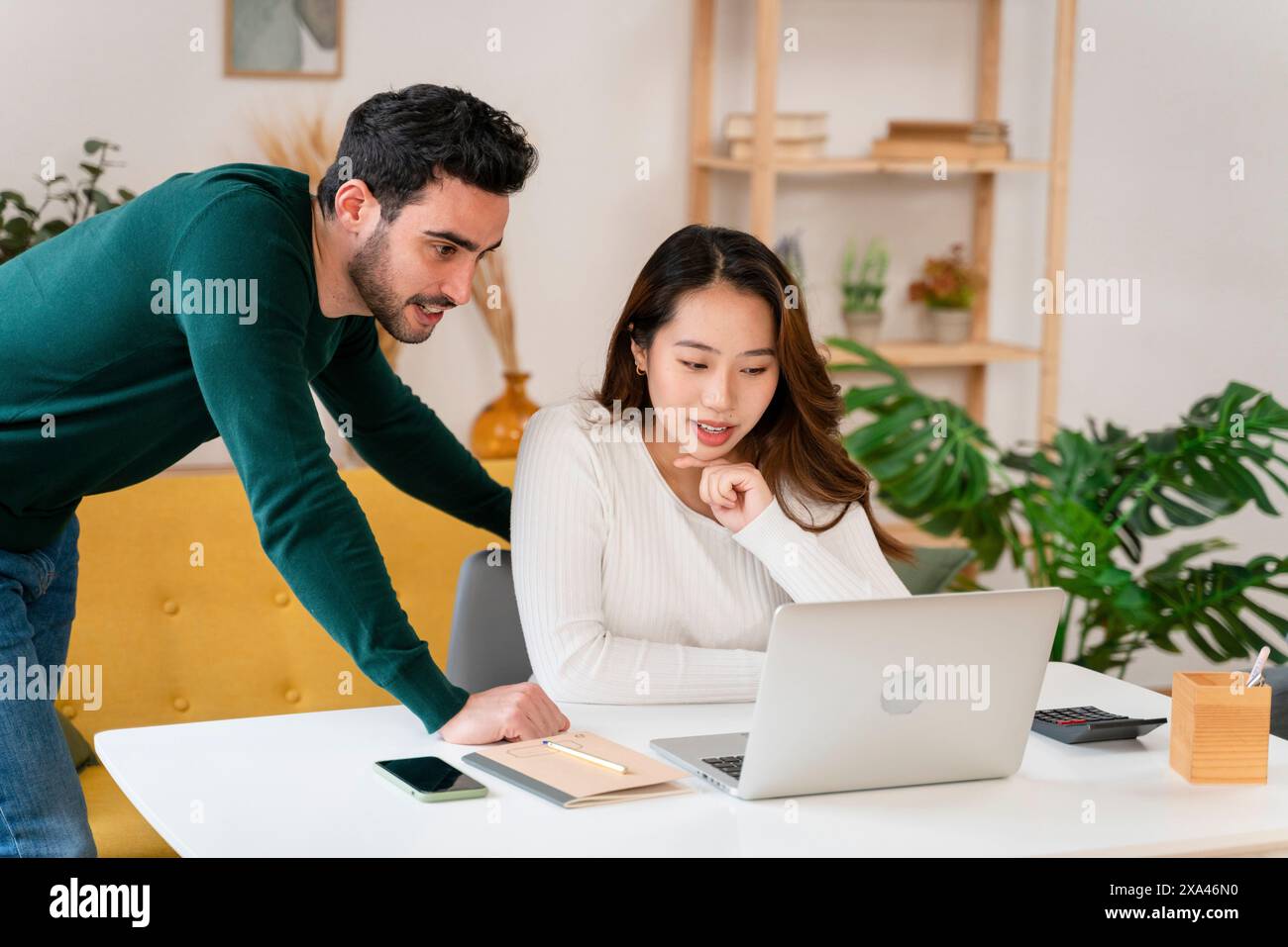 Two professionals are working together desk modern office setting hi-res stock photography and ...