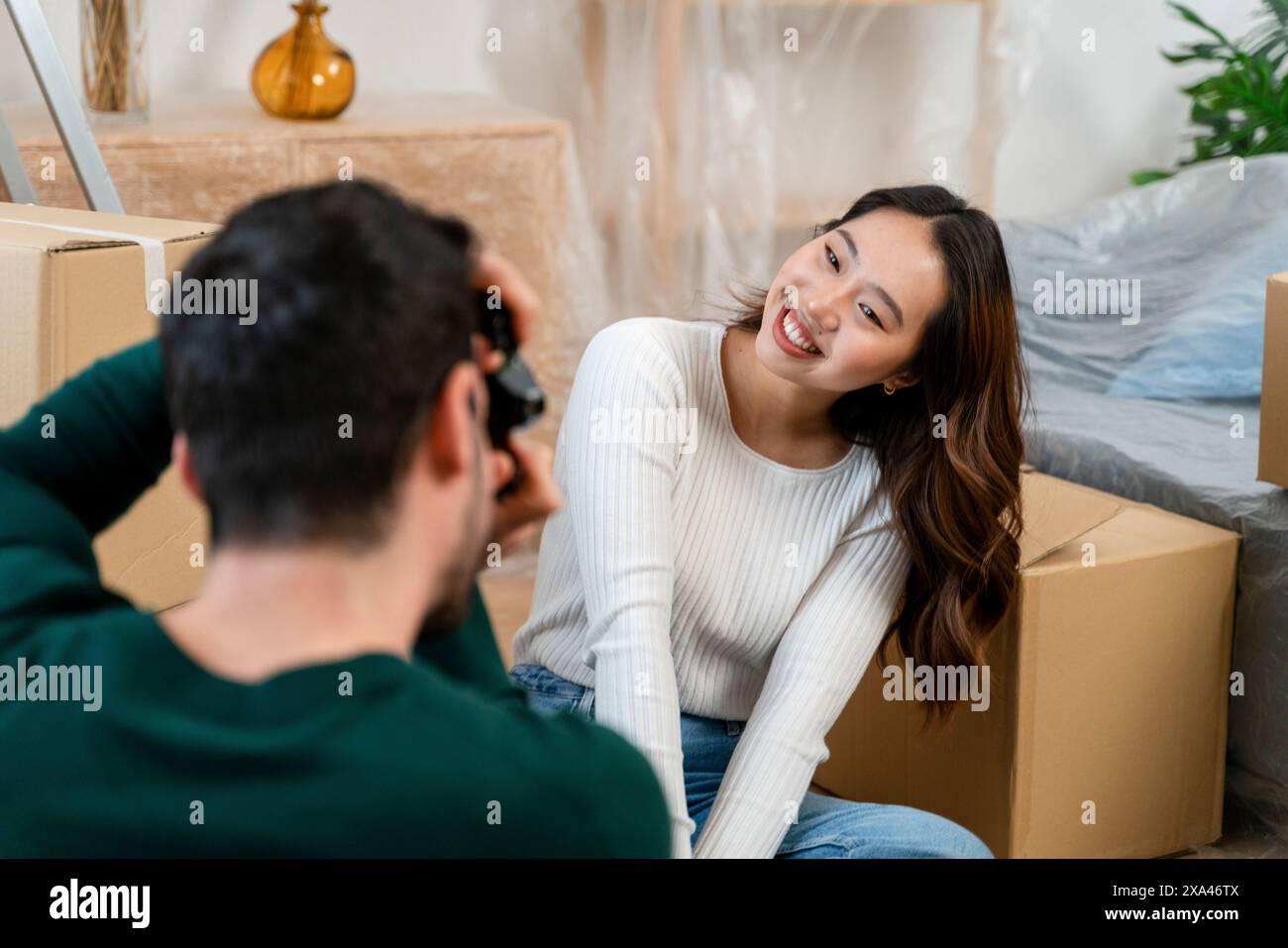 Happy couple unpacking boxes hi-res stock photography and images - Alamy