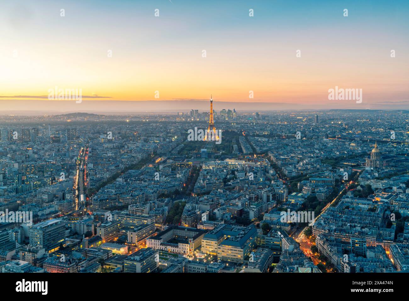 Aerial view of Paris with the Eiffel Tower illuminated at dusk Stock ...