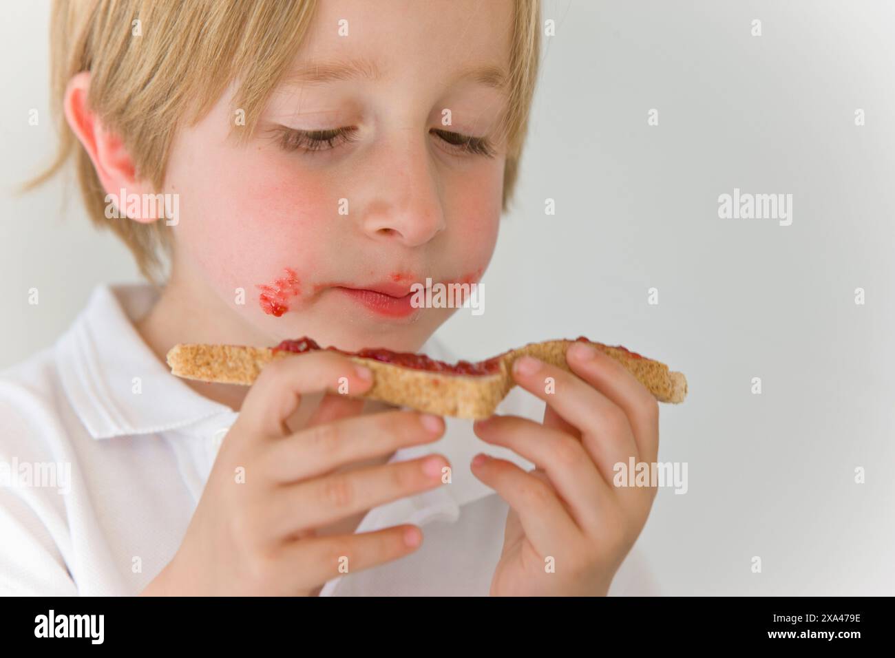 Boy Eating Jam on Toast Stock Photo - Alamy