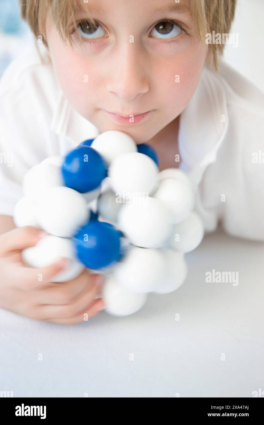 Boy Holding Atom Model Stock Photo - Alamy