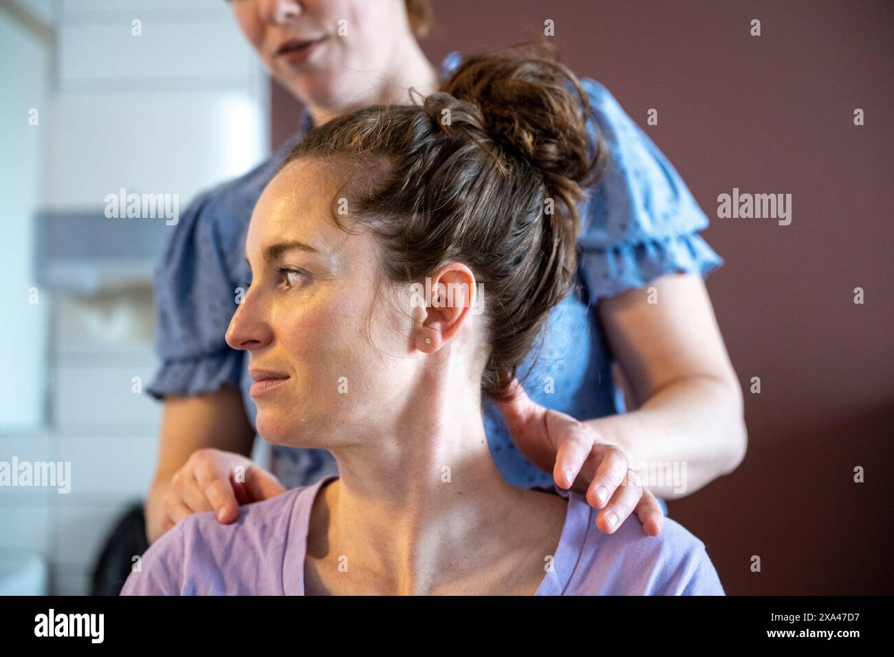 Woman giving another a shoulder massage Stock Photo - Alamy