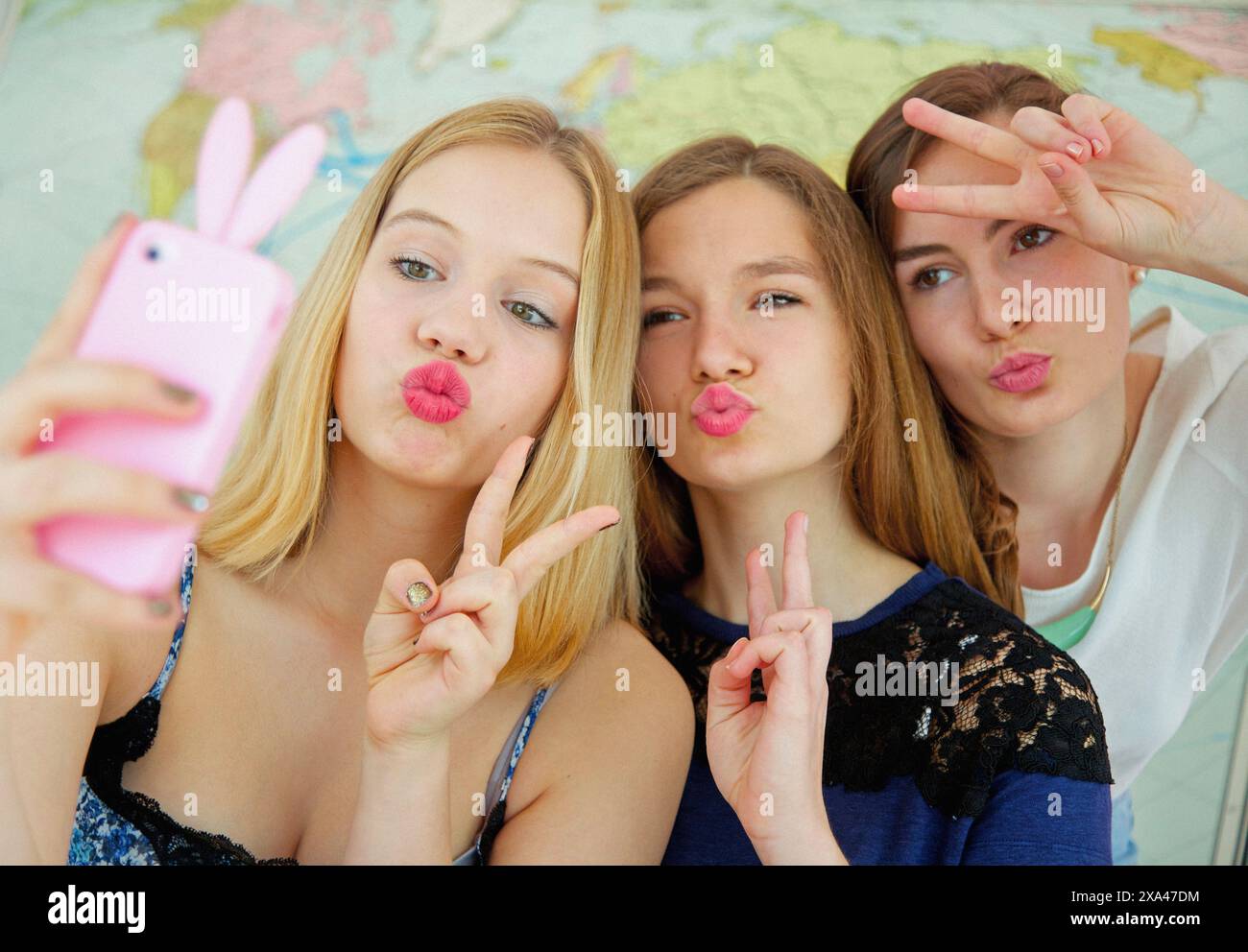 Teenage Girls Taking Selfie whilst Pouting and Making Peace Sign Stock ...