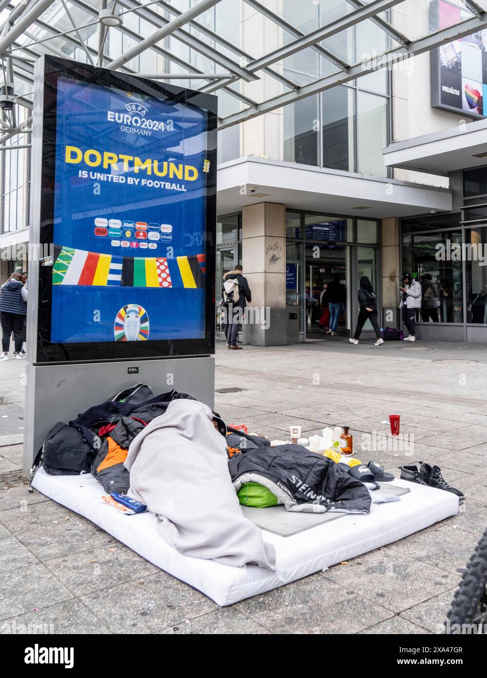Homeless man sleeping in front of the entrance of Dortmund Central ...