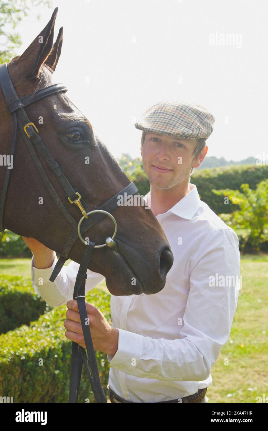 Man standing holding reins horse hi-res stock photography and images ...