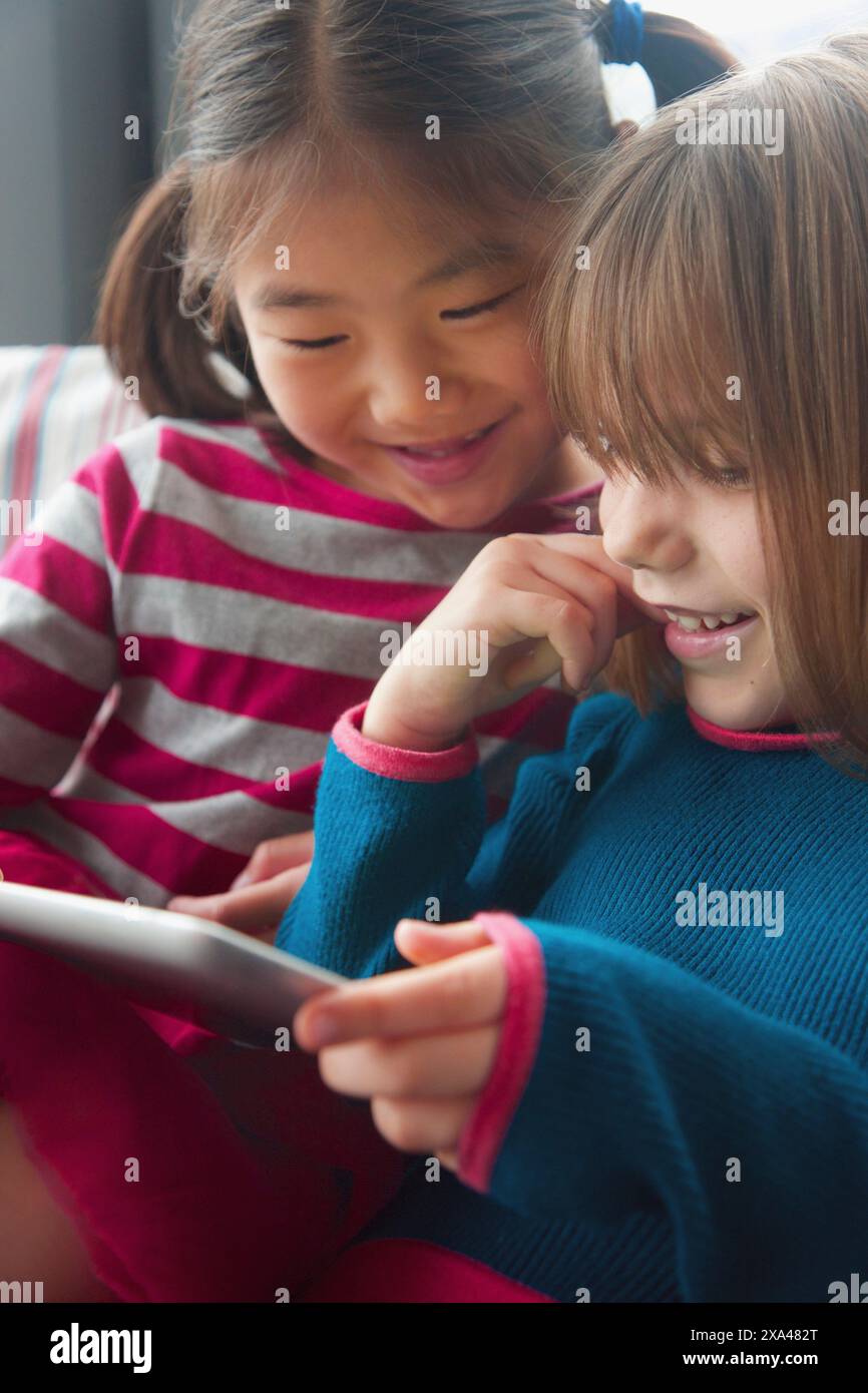 Young Girls Using Digital Tablet Smiling Stock Photo - Alamy