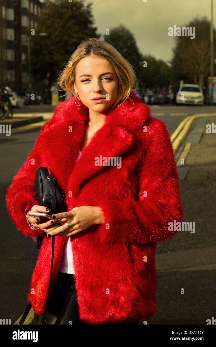 Woman Wearing Red Fake Fur Coat in City Street Stock Photo - Alamy