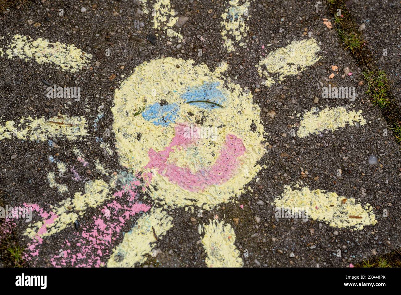 Faded chalk drawing of a sun on pavement Stock Photo - Alamy